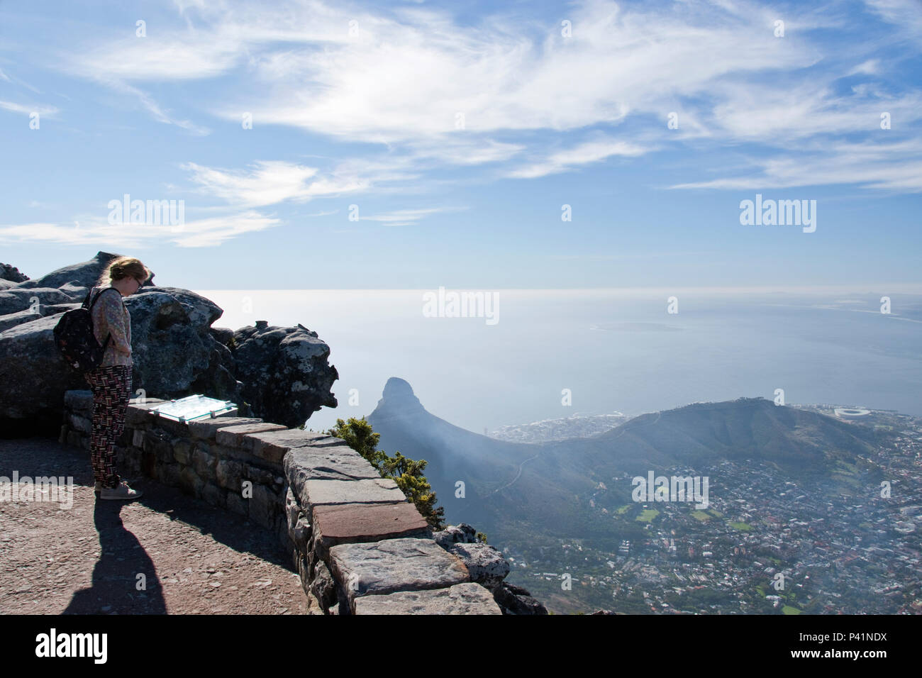 A tourist reads a sign at a viewpoint on top of Table Mountain, the ...