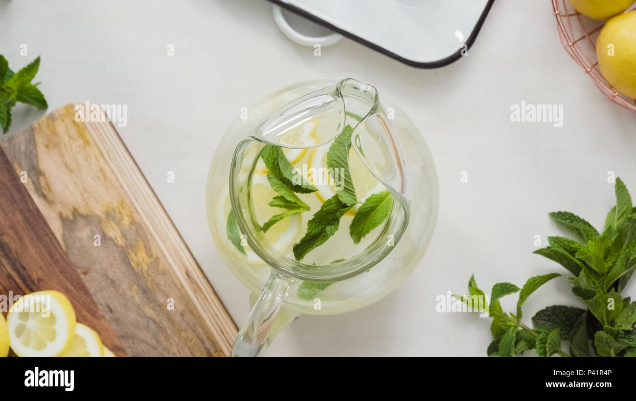 Preparing traditional lemonade with fresh sliced lemons and mint Stock ...
