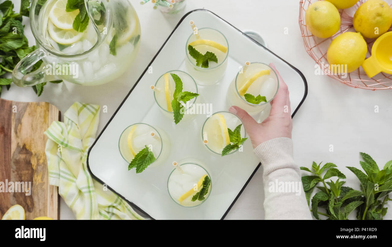 Tray with traditional lemonade with fresh sliced lemons and mint Stock ...