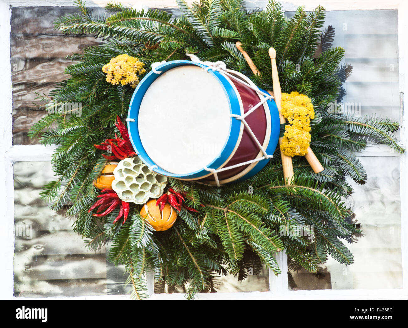 Unusual musical Christmas wreath made of a blue and red toy drum ...