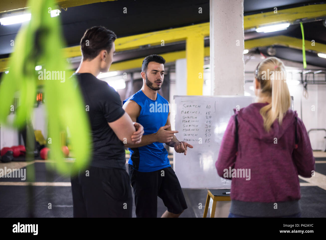 Training course.group of young athletes getting instructions from ...