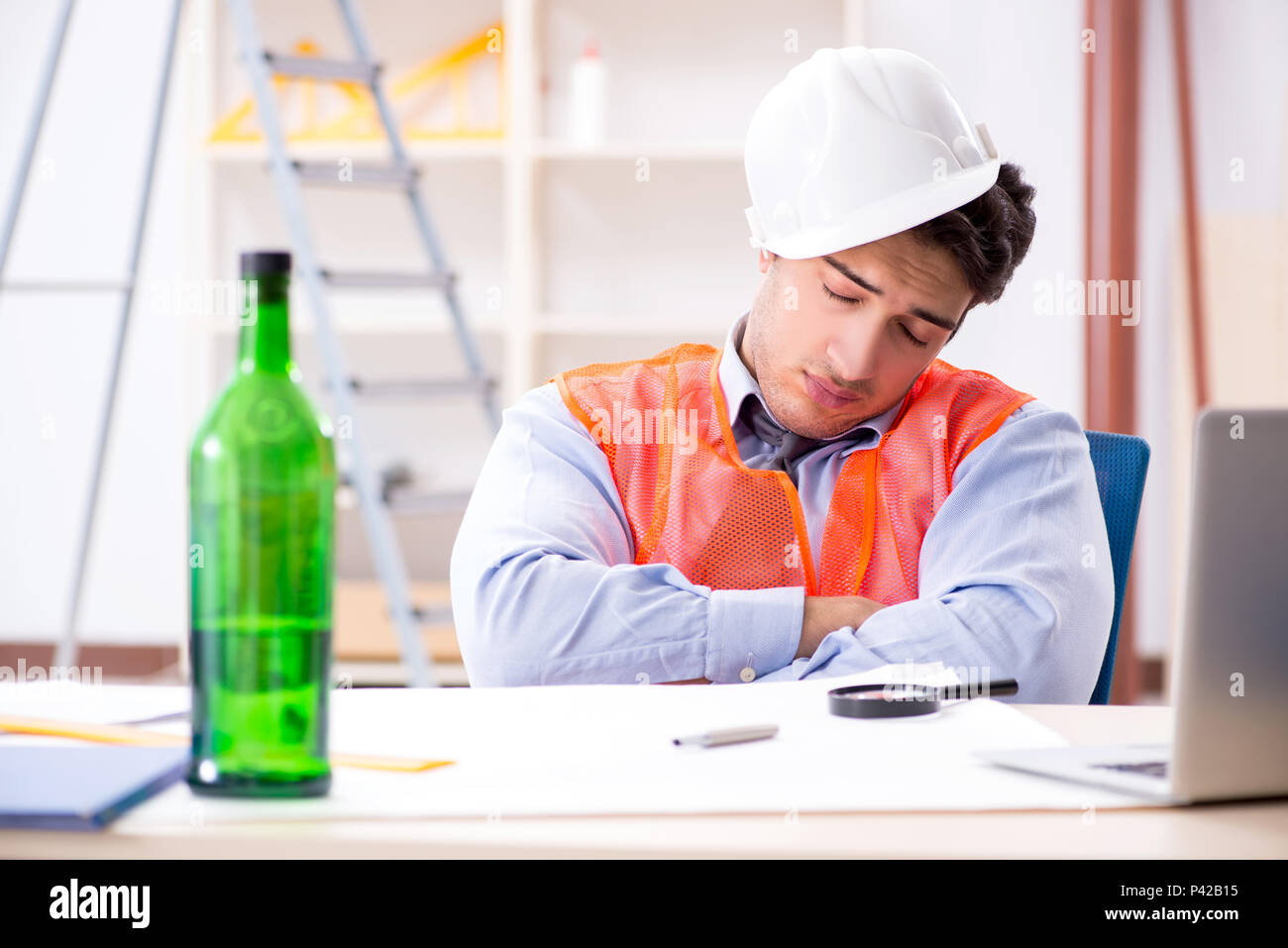 Drunk engineer working in the workshop Stock Photo - Alamy