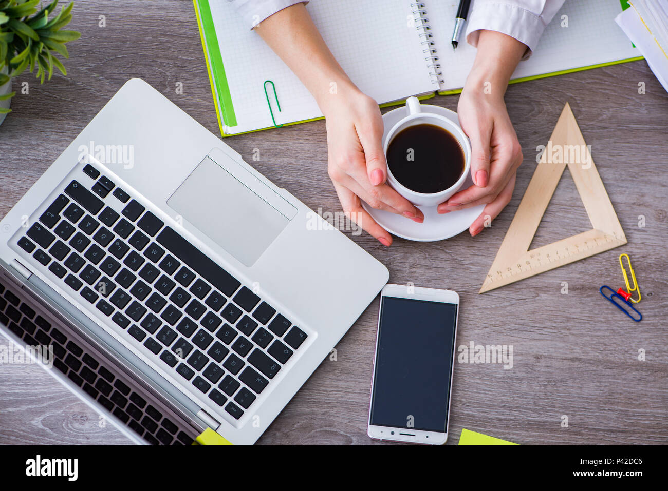 Top view of working desk with hands Stock Photo - Alamy