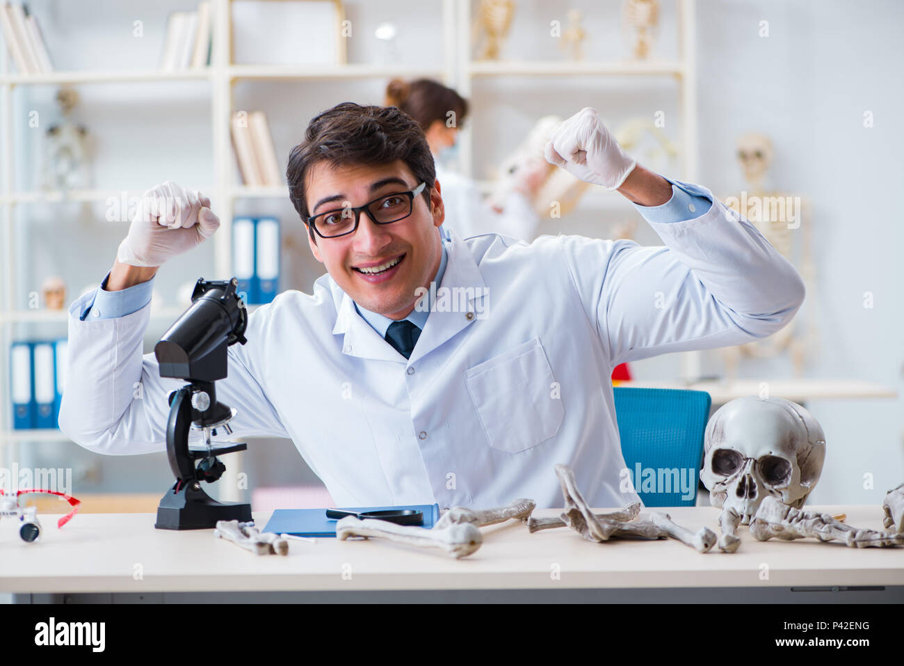 Professor studying human skeleton in lab Stock Photo - Alamy