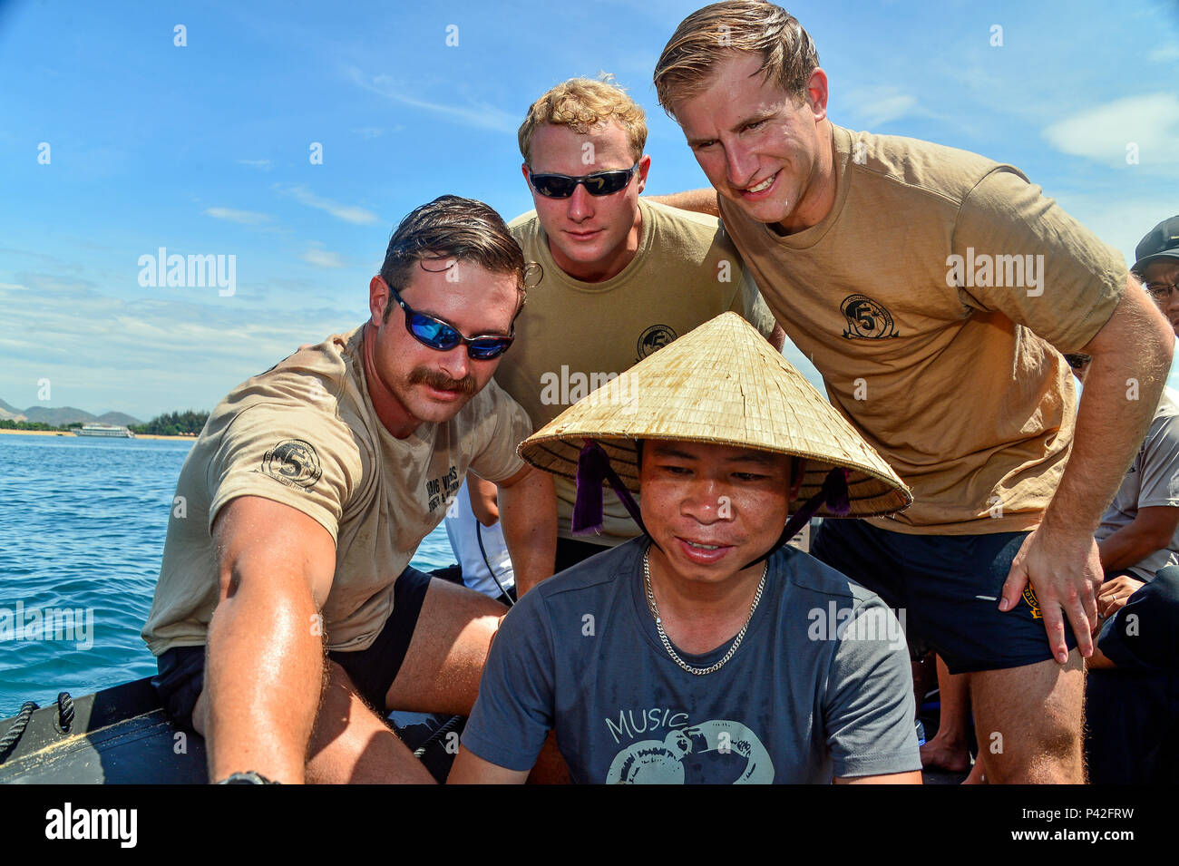 A member of the Vietnam People’s Navy (middle) takes instruction on ...