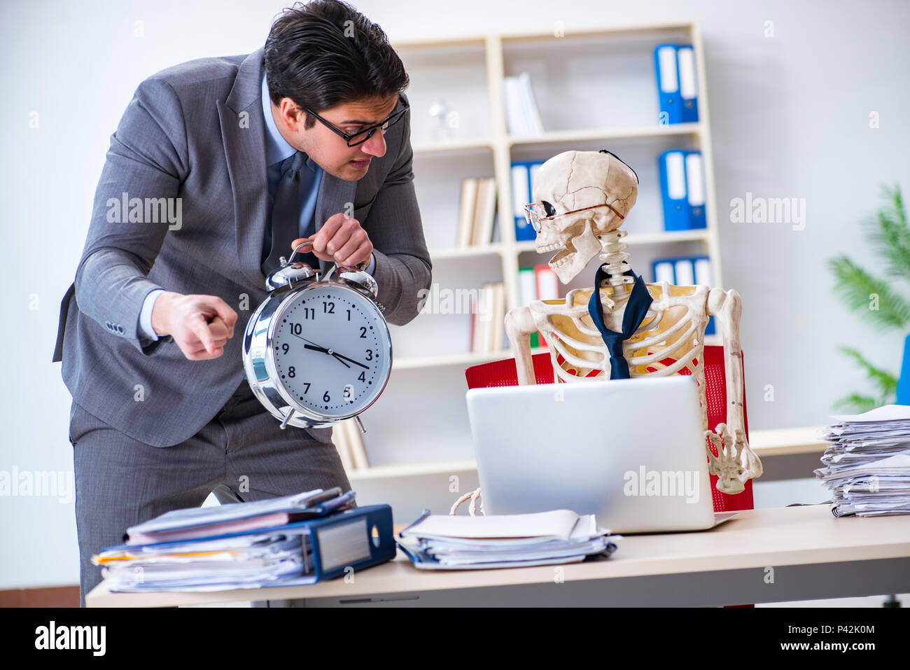Angry boss yelling at his skeleton employee Stock Photo - Alamy