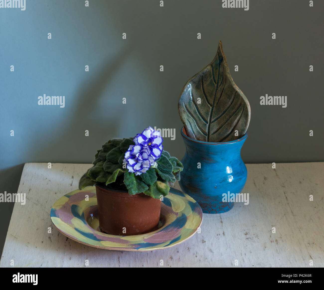 still life with handmade dishes and violet. ceramics. pottery Stock ...