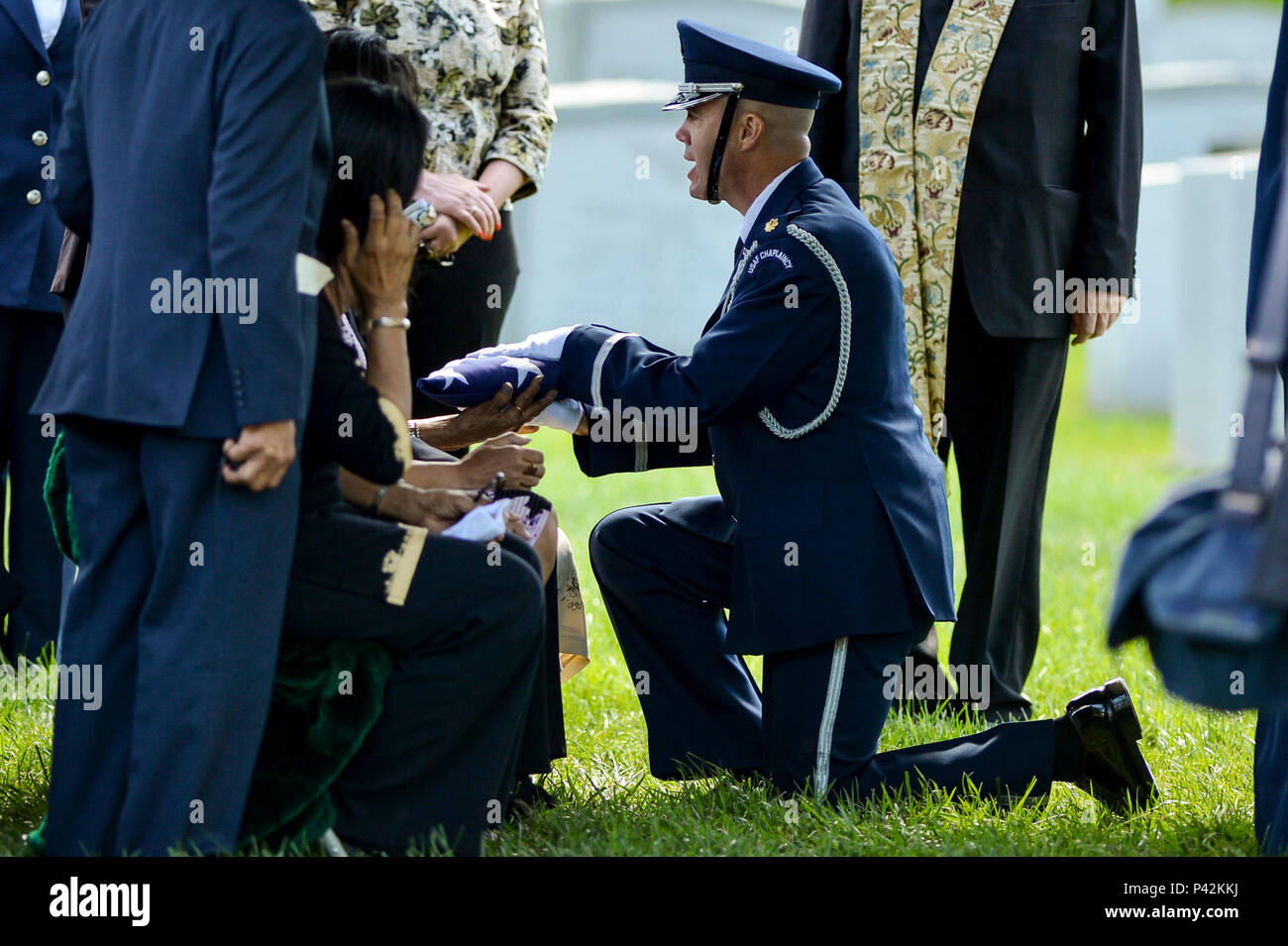 U.S. Air Force Chaplain Maj. Kevin Hudson presents the U.S. flag to ...