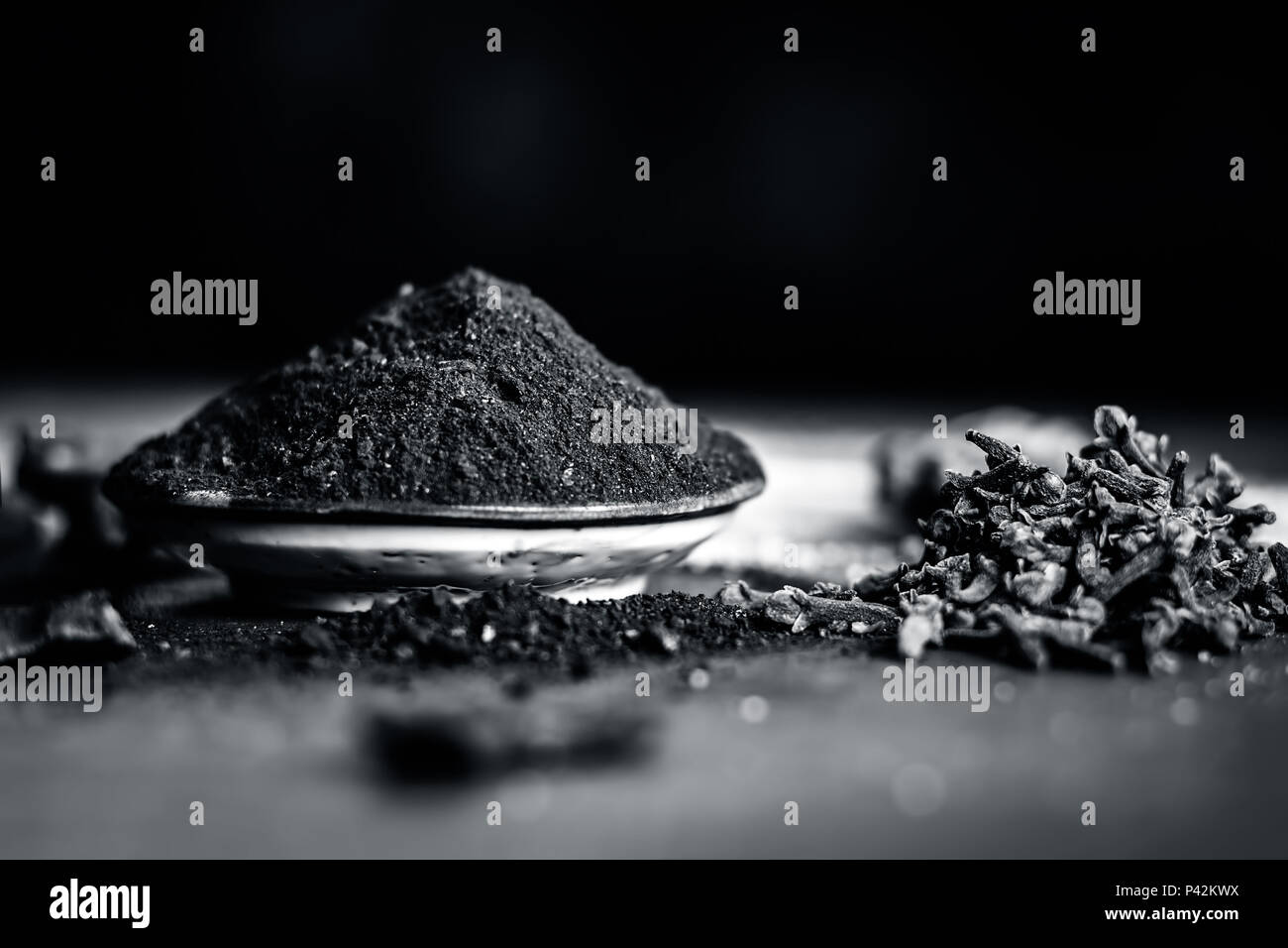 Powder of coal with raw coal and clove Stock Photo - Alamy
