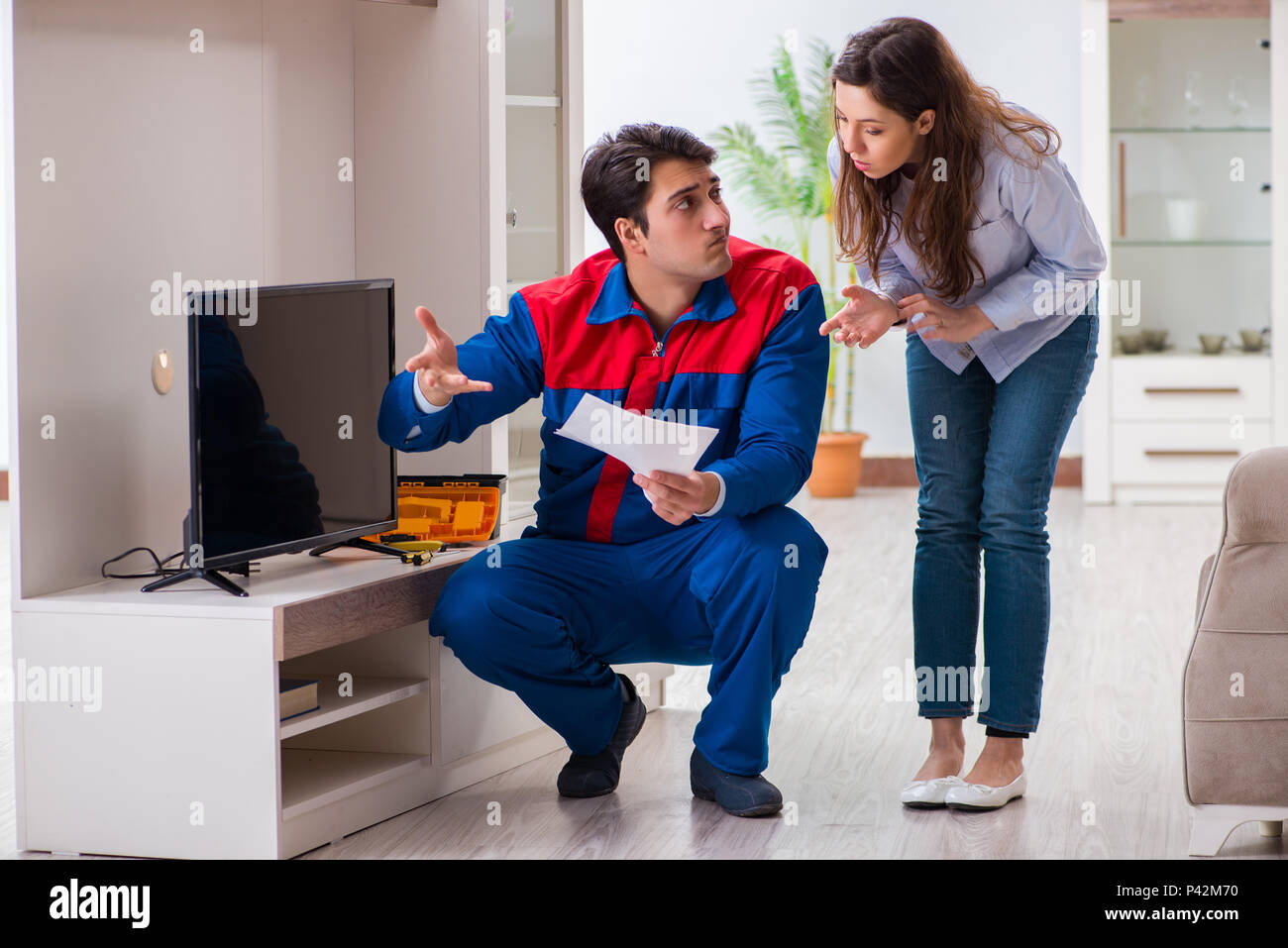 Repairman repairing tv at home Stock Photo - Alamy