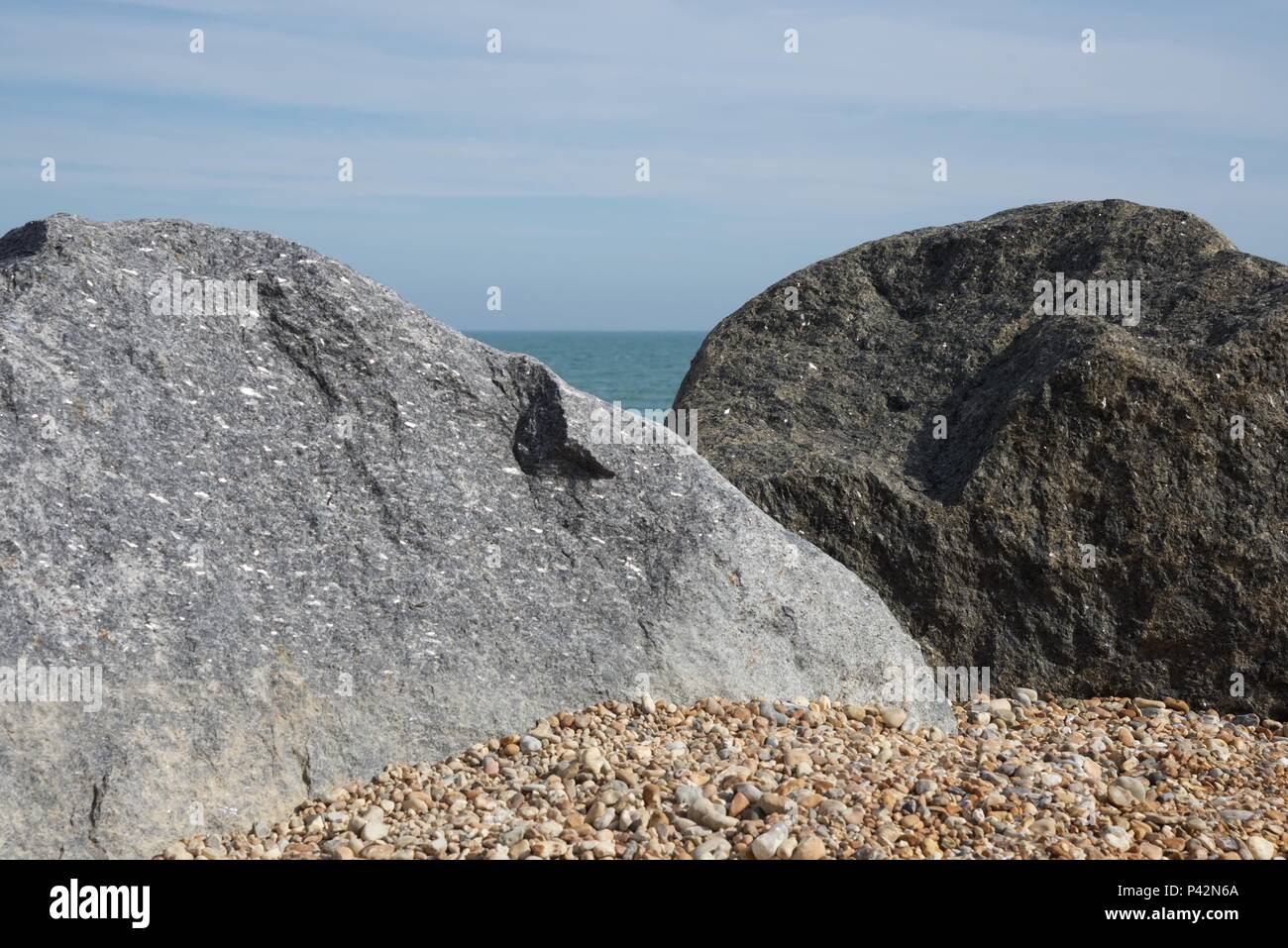 Beach: granite boulders on a pebble beach overlooking the English ...