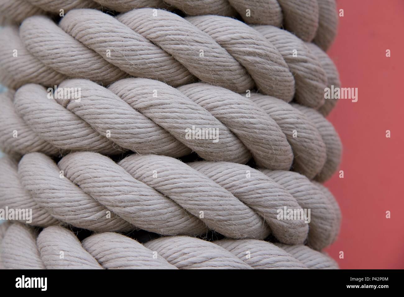 Rope: rope coiled around a supporting steel post Stock Photo - Alamy