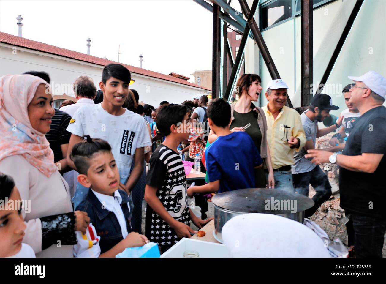 Kids getting food during the celebration. Greek citizens and refugees ...