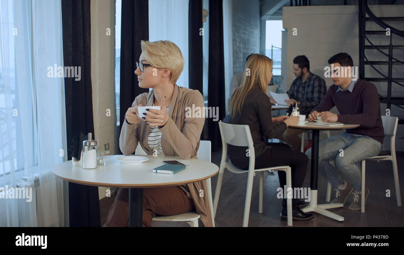 Beautiful young woman sitting table hi-res stock photography and images ...