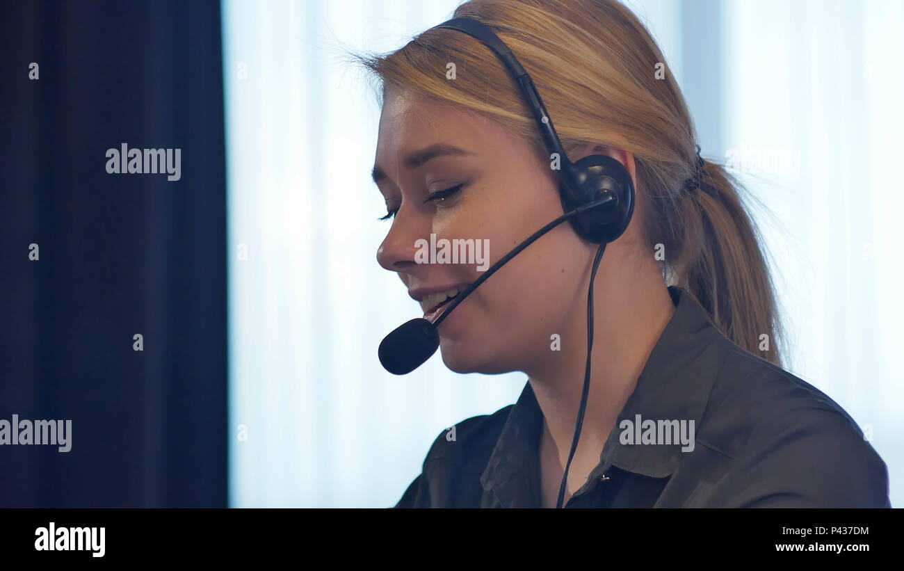 Female customer support operator with headset talking and smiling Stock Photo - Alamy