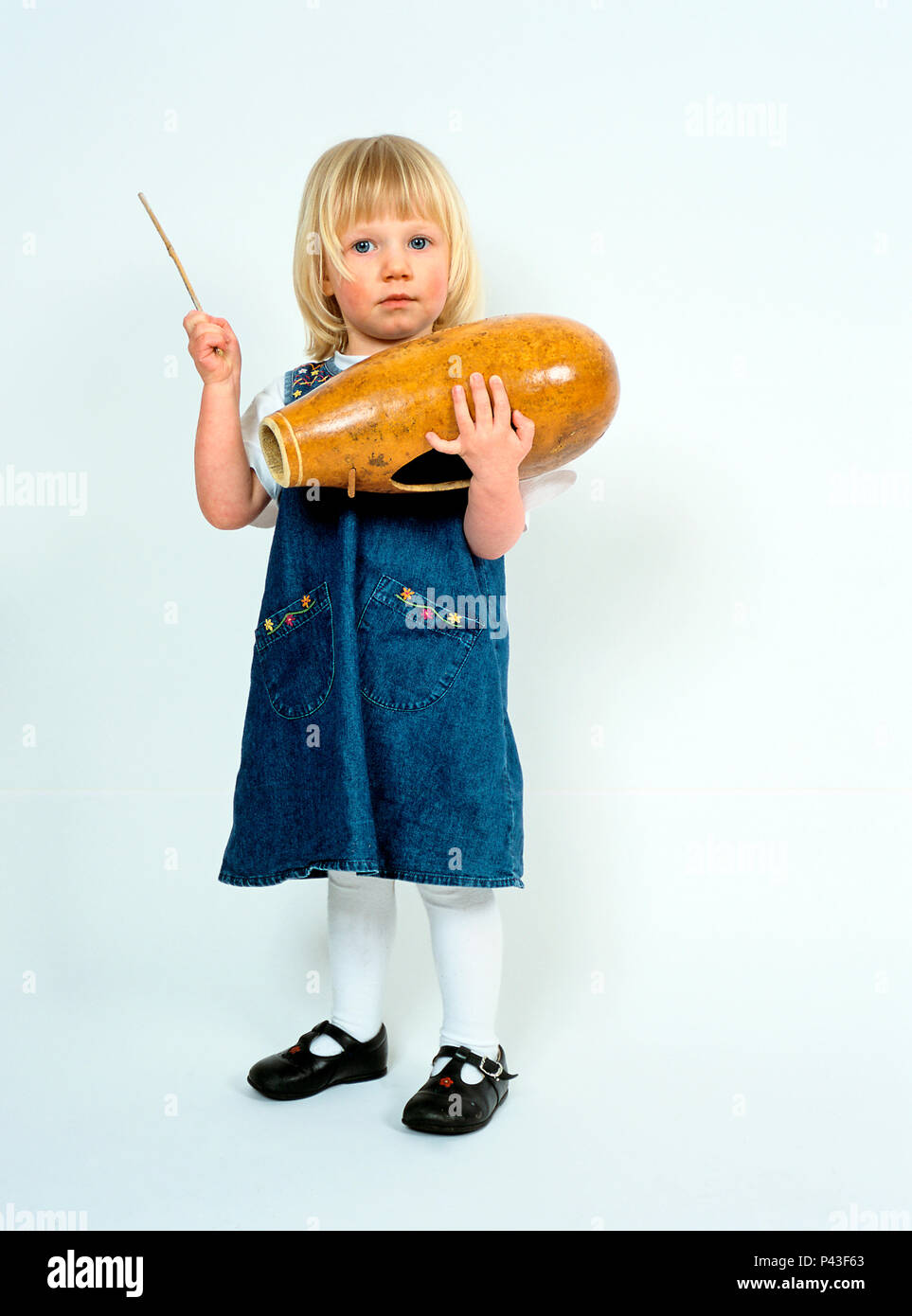 child playing a Guiro Stock Photo - Alamy
