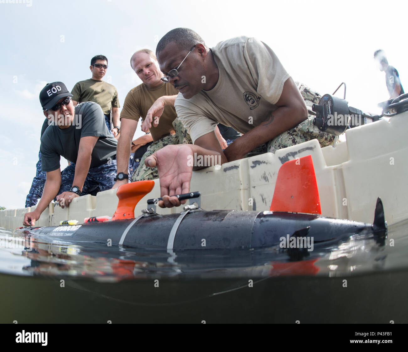 A U.S. Navy Sailor (right) assigned to Explosive Ordnance Disposal (EOD ...