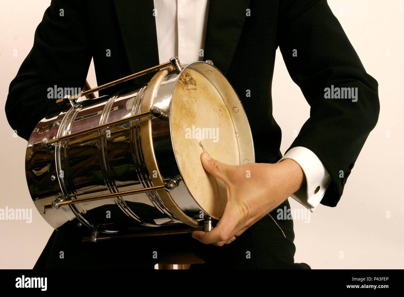 Cuica in playing position, showing one hand (not visible) inside drum ...