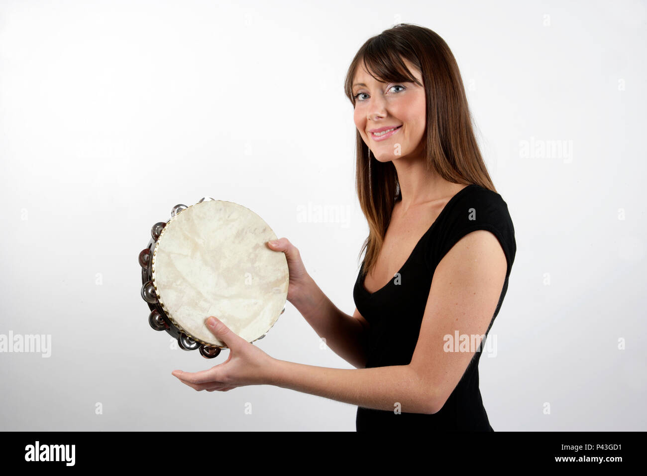 Woman playing a tambourine hi-res stock photography and images - Alamy