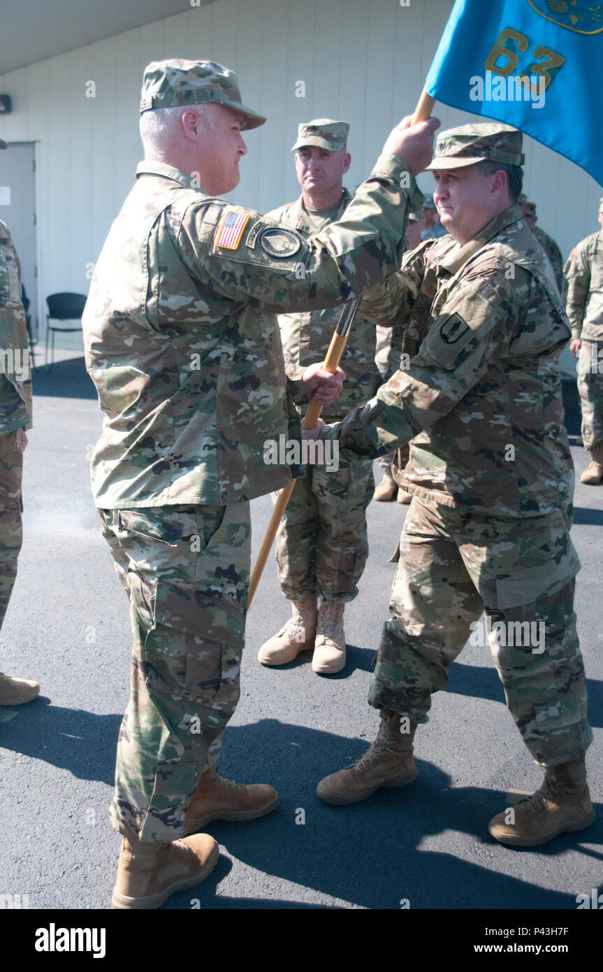 Lt. Col. Scott Houck hands off the unit colors to Col. John Zenker ...