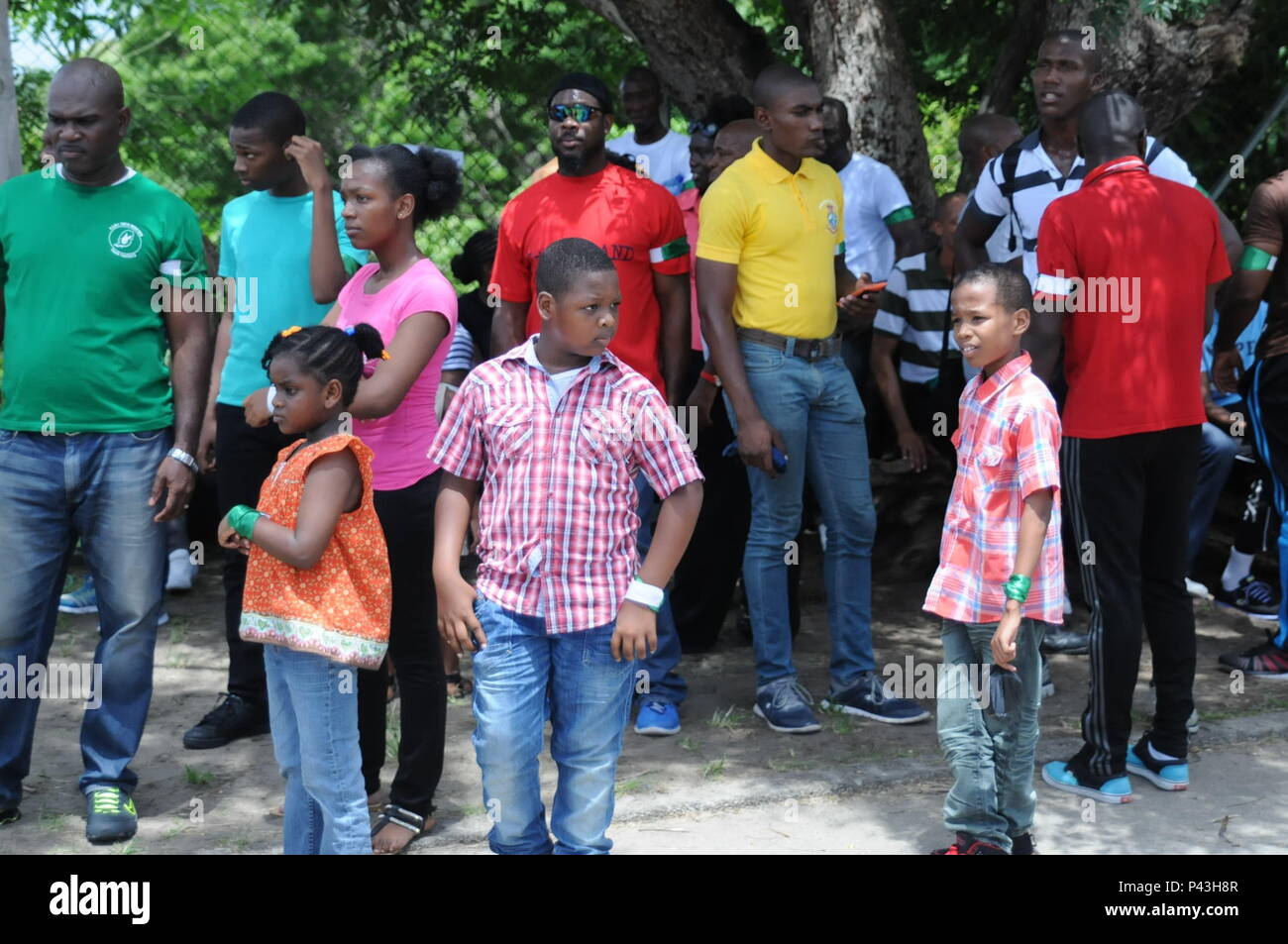 Volunteers wait at an evacuation rally point during a training exercise ...