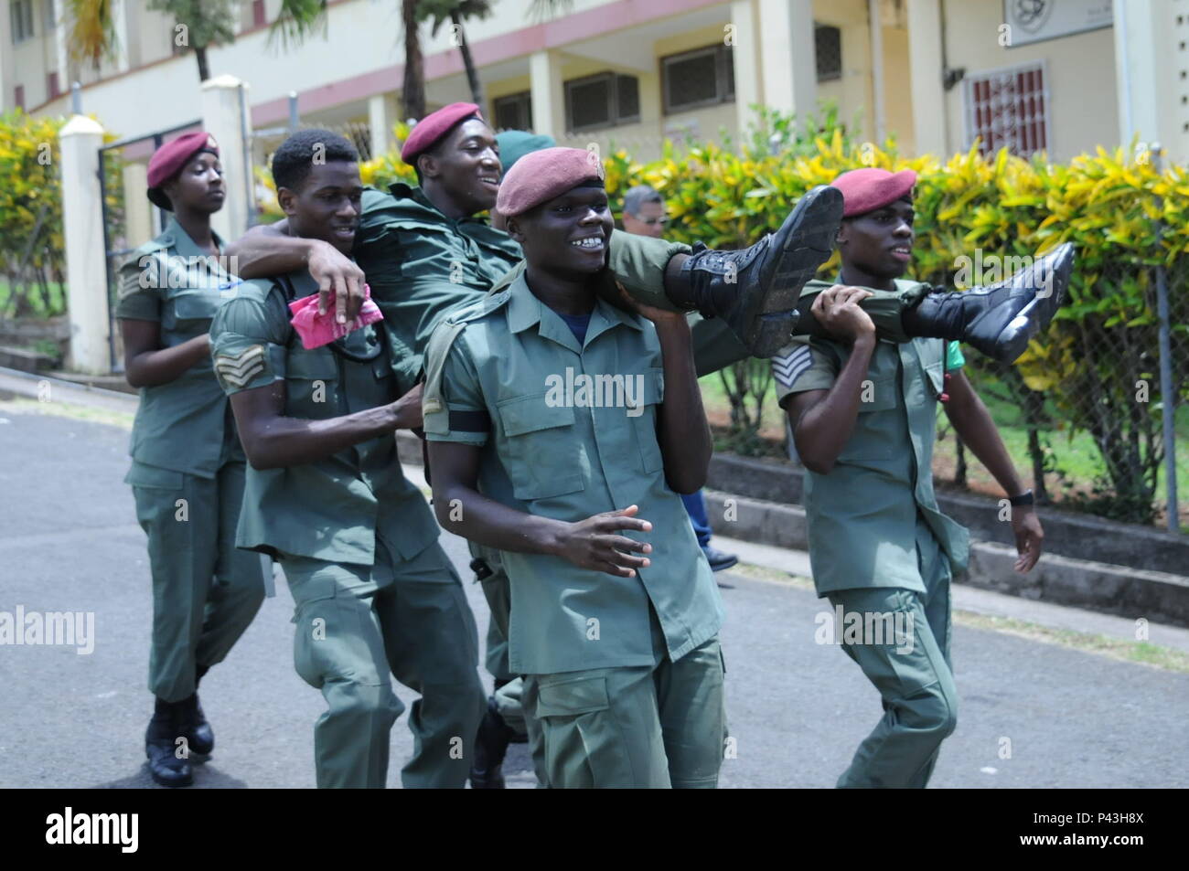 Volunteers move another volunteer with an injured ankle to an ...
