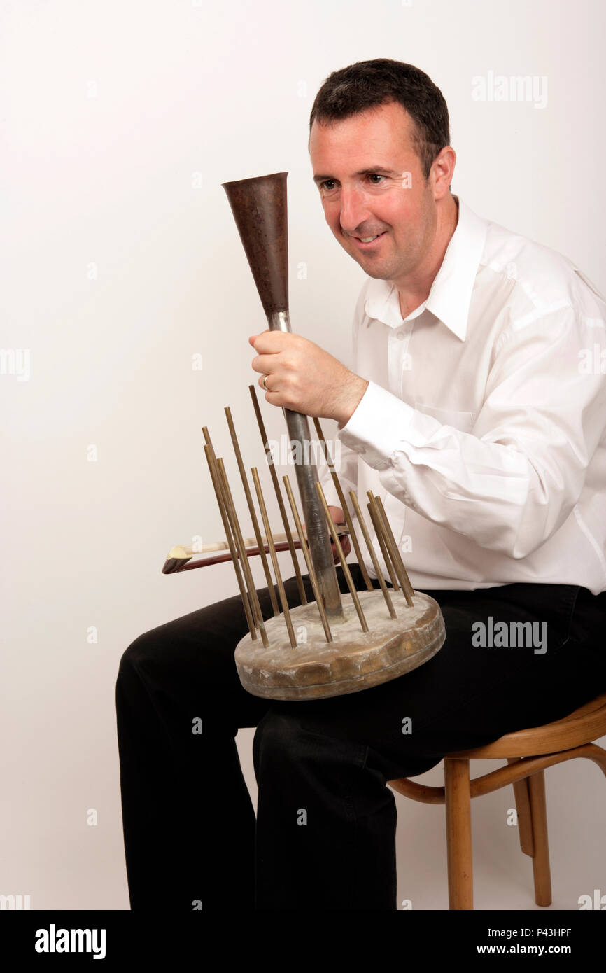 Waterphone being played by a male performer, Generic Stock Photo - Alamy
