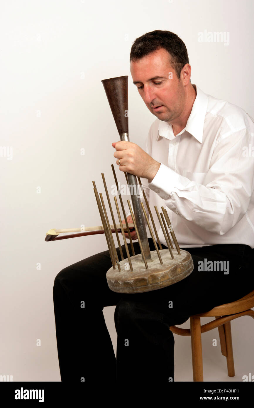 Waterphone being played by a male performer, Generic Stock Photo - Alamy