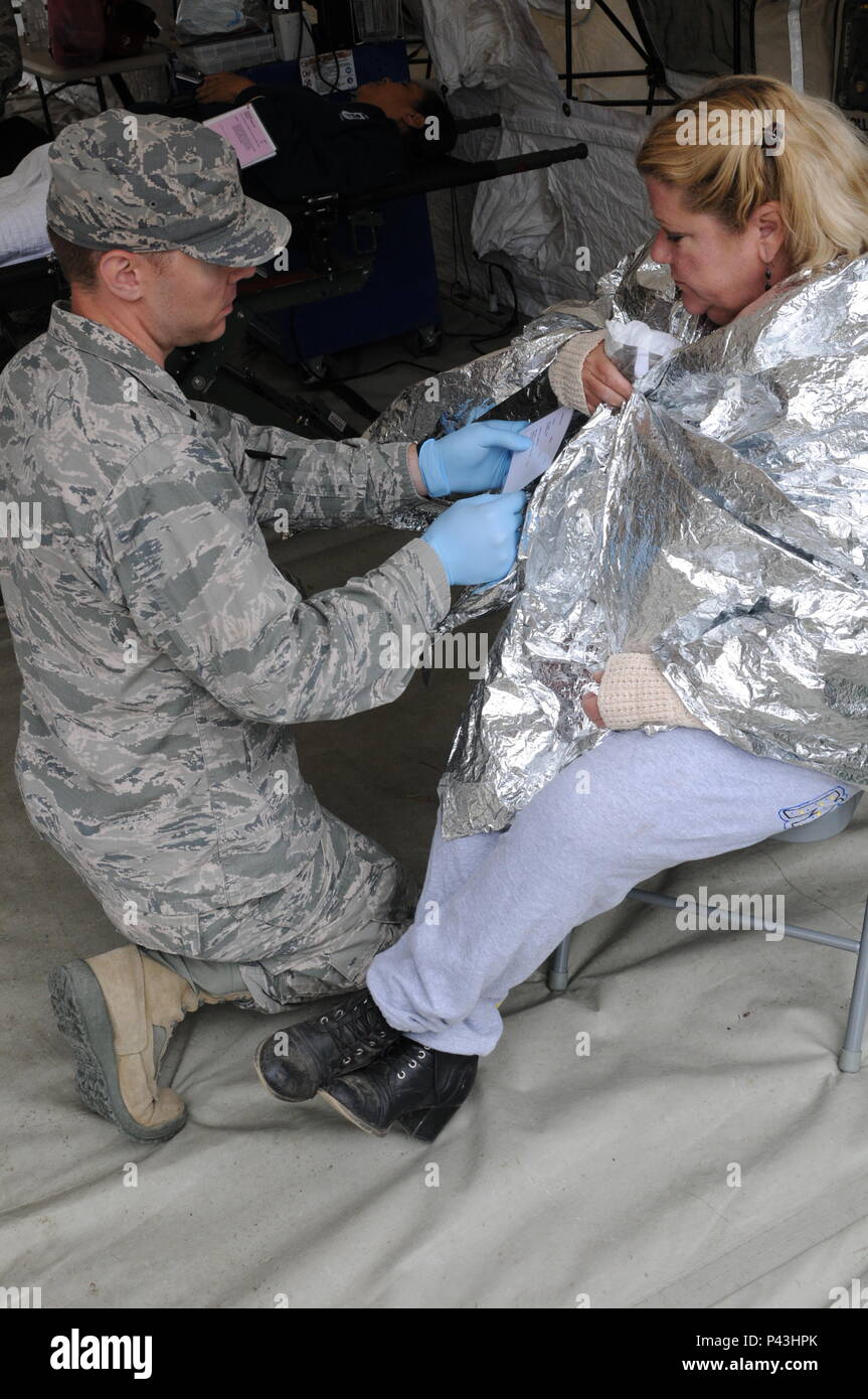 An Oregon National Guardsman evaluates a patient in a field medical ...
