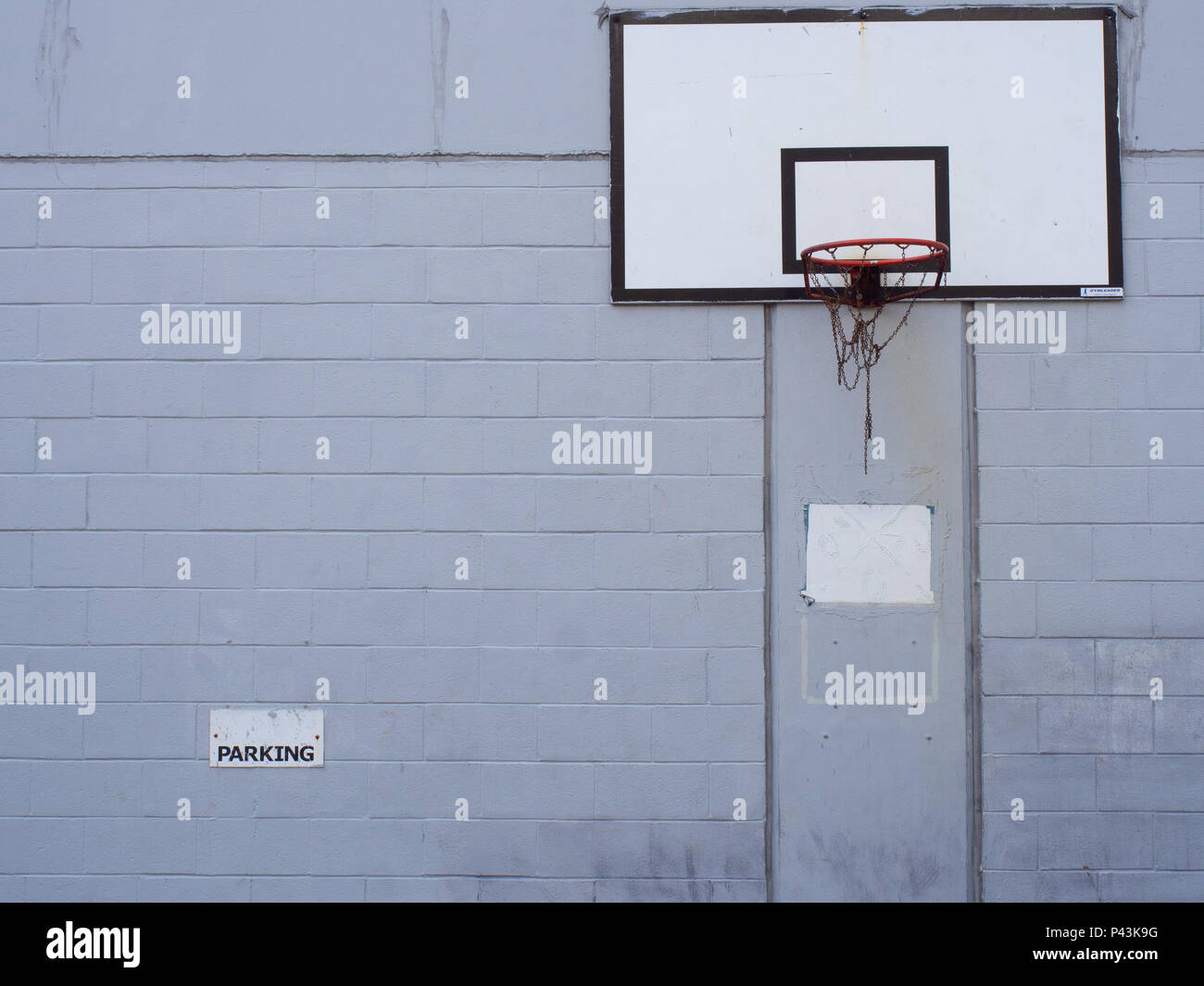 Outdoor Basketball Hoop And A Parking Sign Stock Photo - Alamy