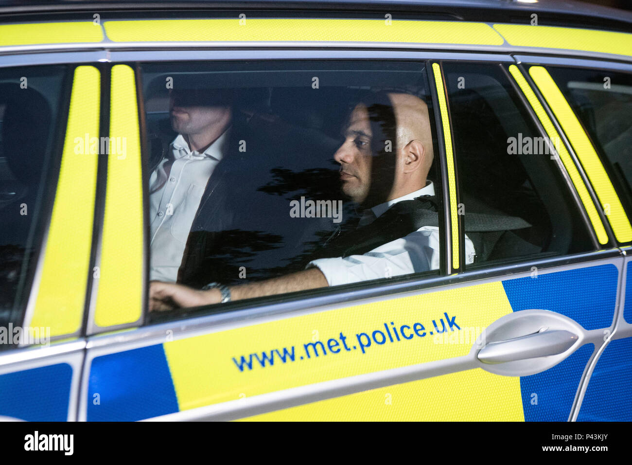 Home Secretary Sajid Javid sits in a police car during a visit to ...