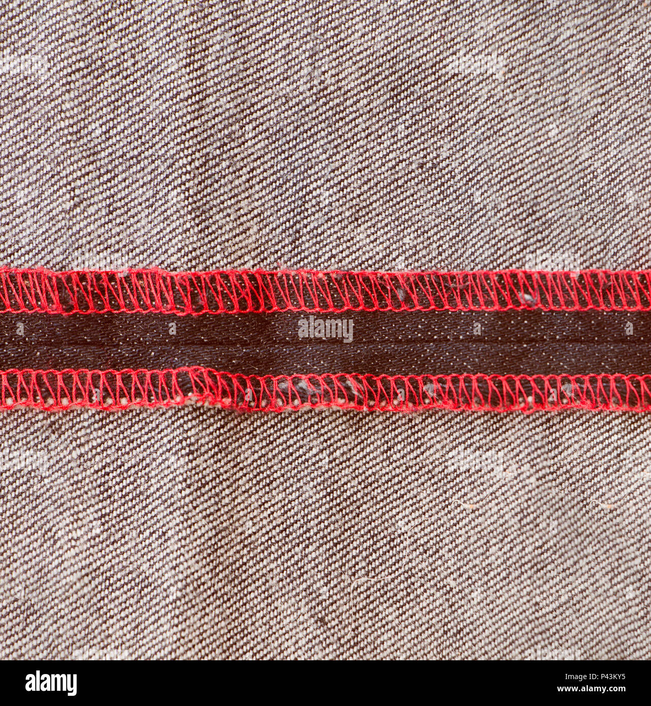 Denim texture with red seam for jeans background Stock Photo - Alamy