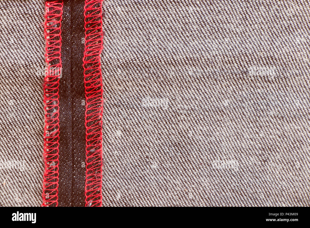 Denim texture with red seam for jeans background Stock Photo - Alamy