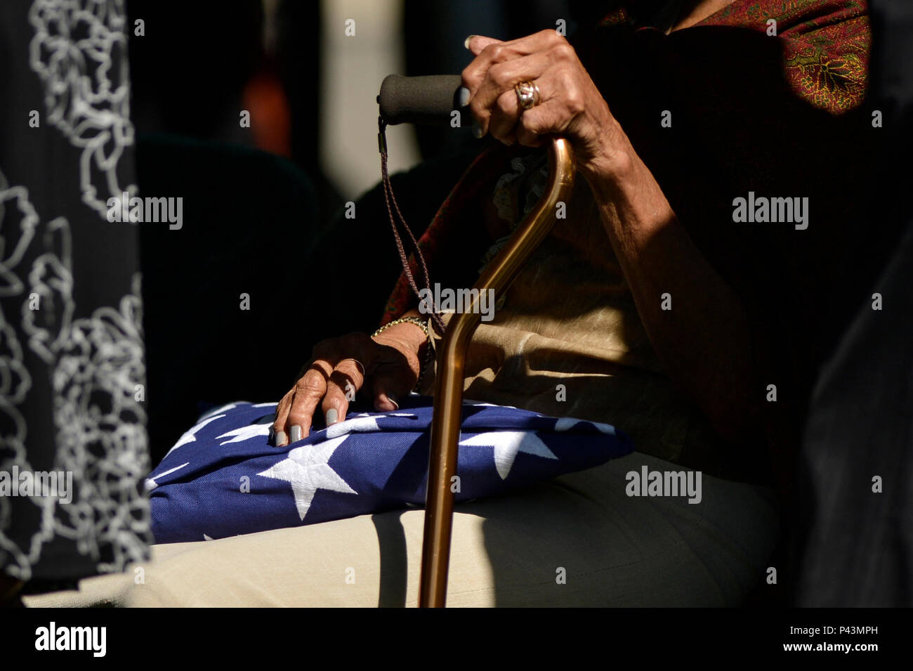 Nola Whitfield embraces her husband’s flag during the gravesite ...