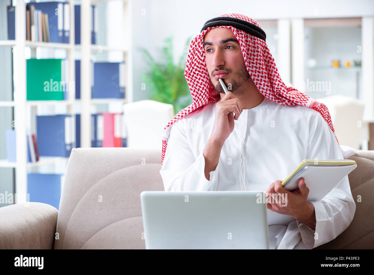 Arab man working at home on his work Stock Photo - Alamy