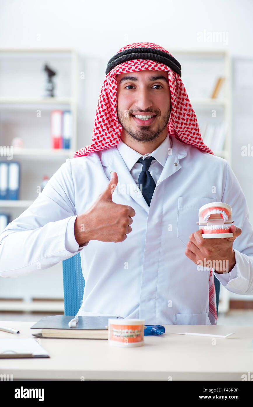 Arab dentist working on new teeth implant Stock Photo - Alamy