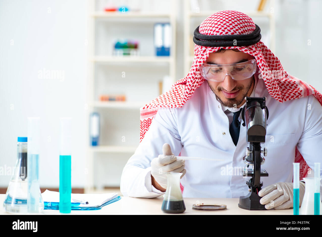Arab chemist working in the lab office Stock Photo - Alamy