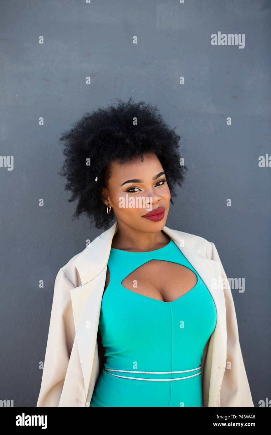An African female model poses alongside a darkly contrasted wall Stock ...