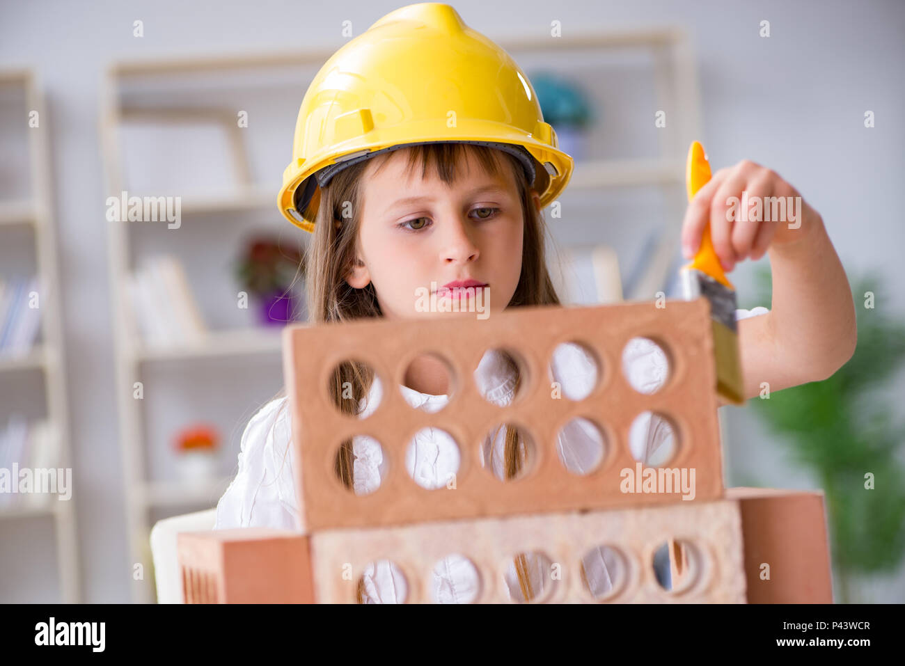 Young girl building with construction bricks Stock Photo - Alamy