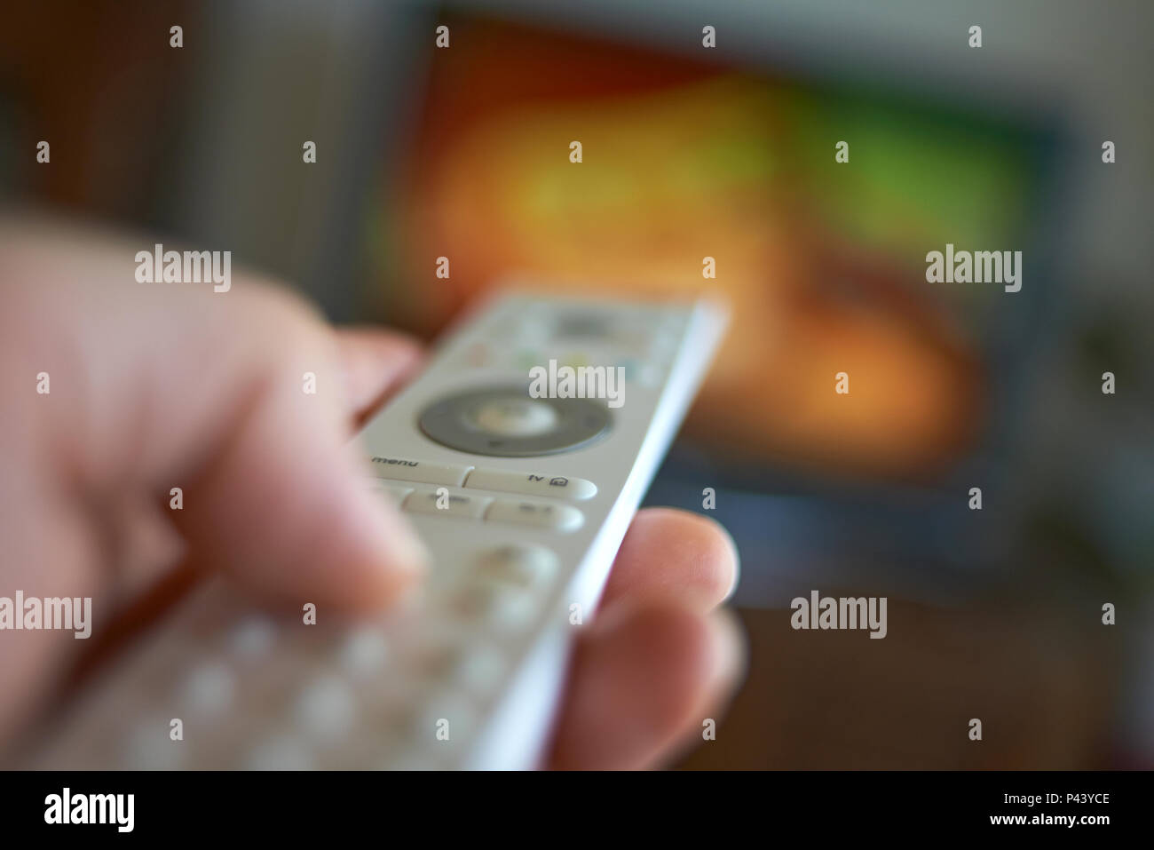 Extreme close up shot of a hand holding a television remote control and ...