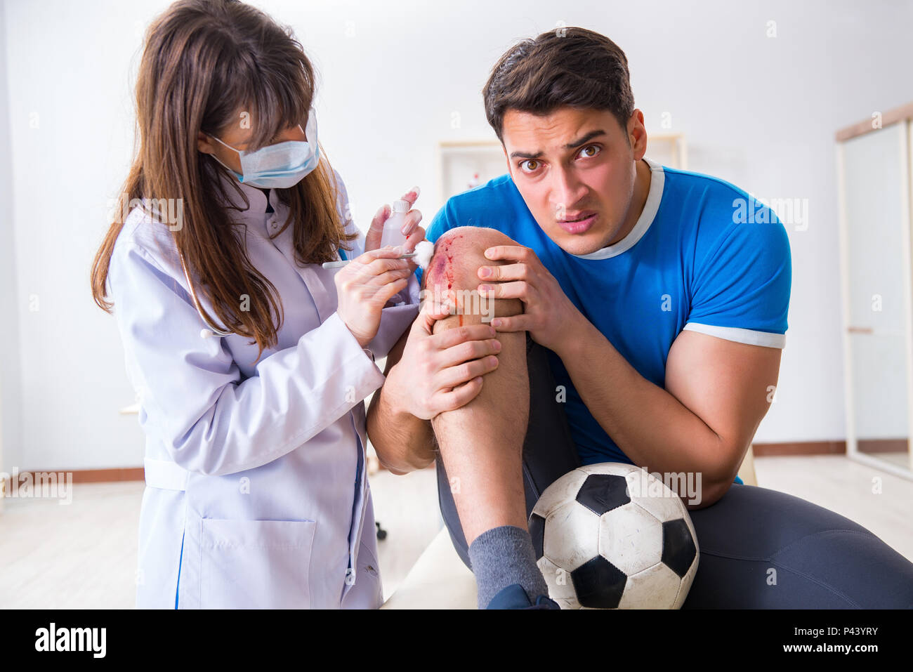 Football soccer player visiting doctor after injury Stock Photo - Alamy