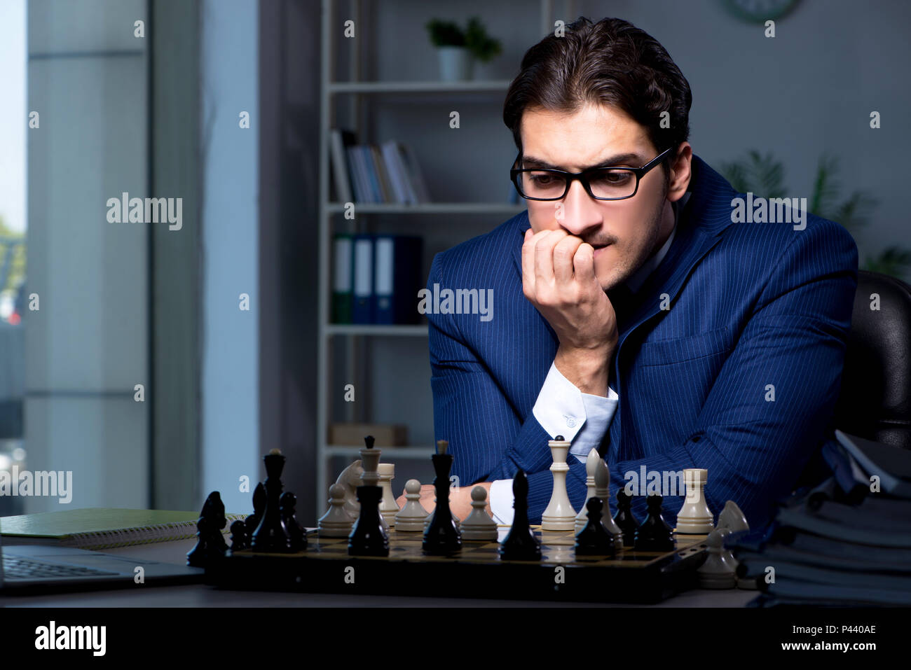 Businessman playing chess in strategy concept Stock Photo - Alamy