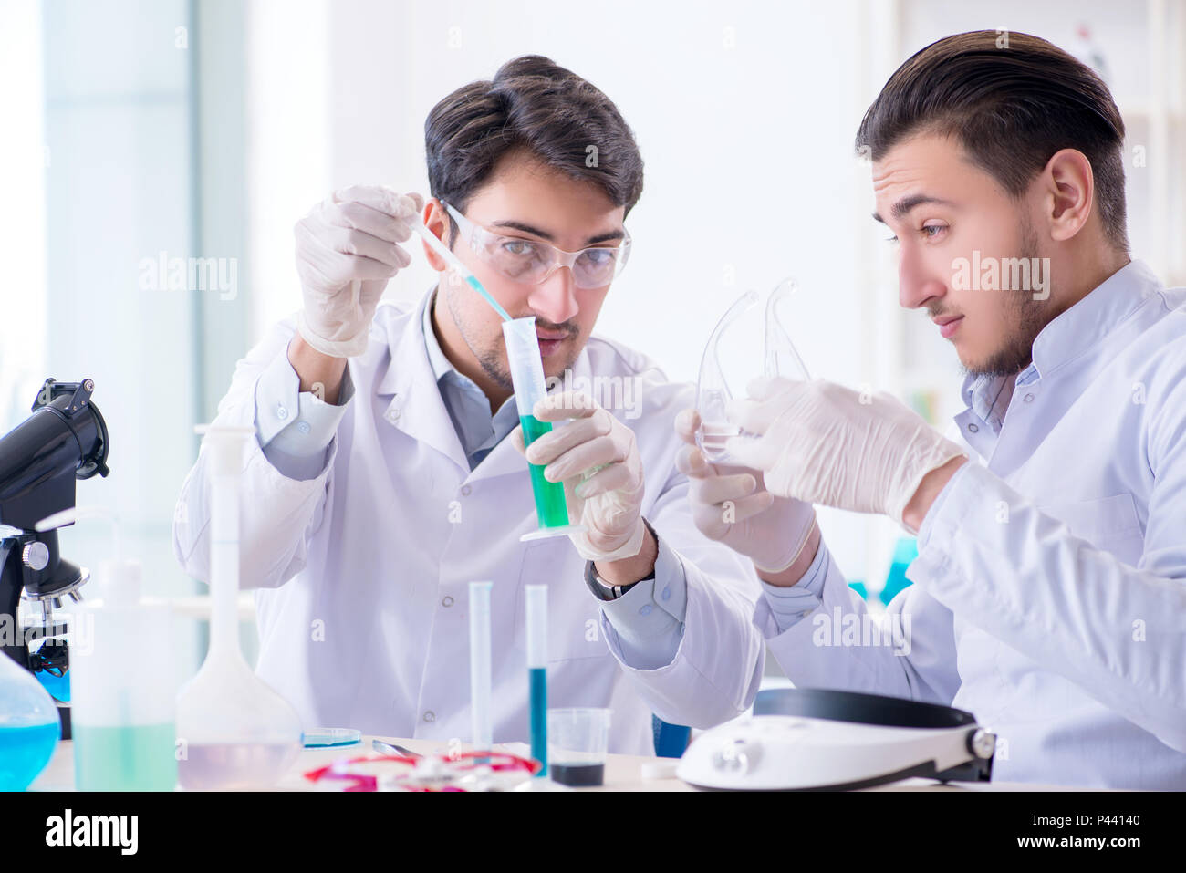 Team of chemists working in the lab Stock Photo - Alamy