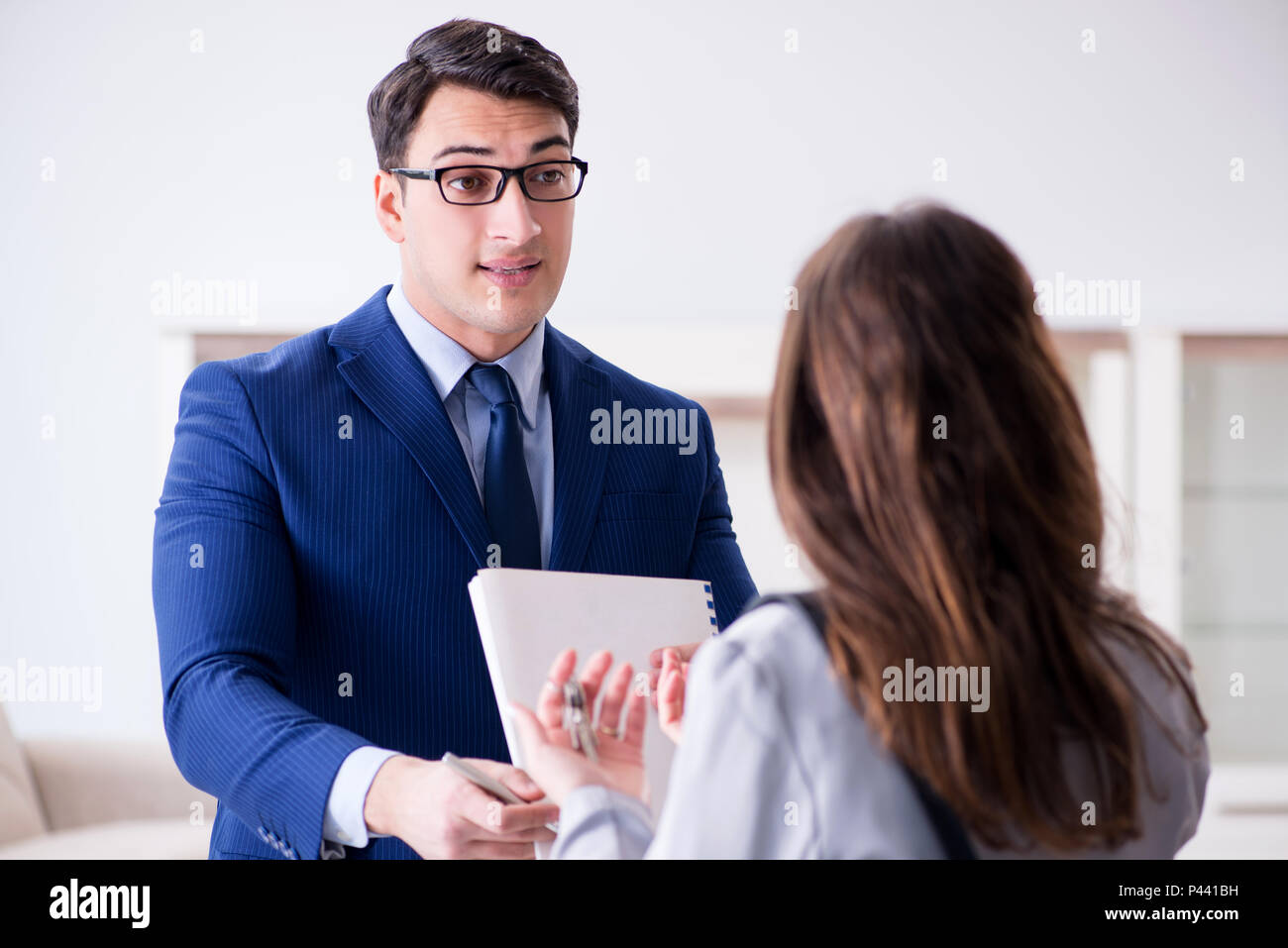 Real estate agent showing new apartment to owner Stock Photo - Alamy