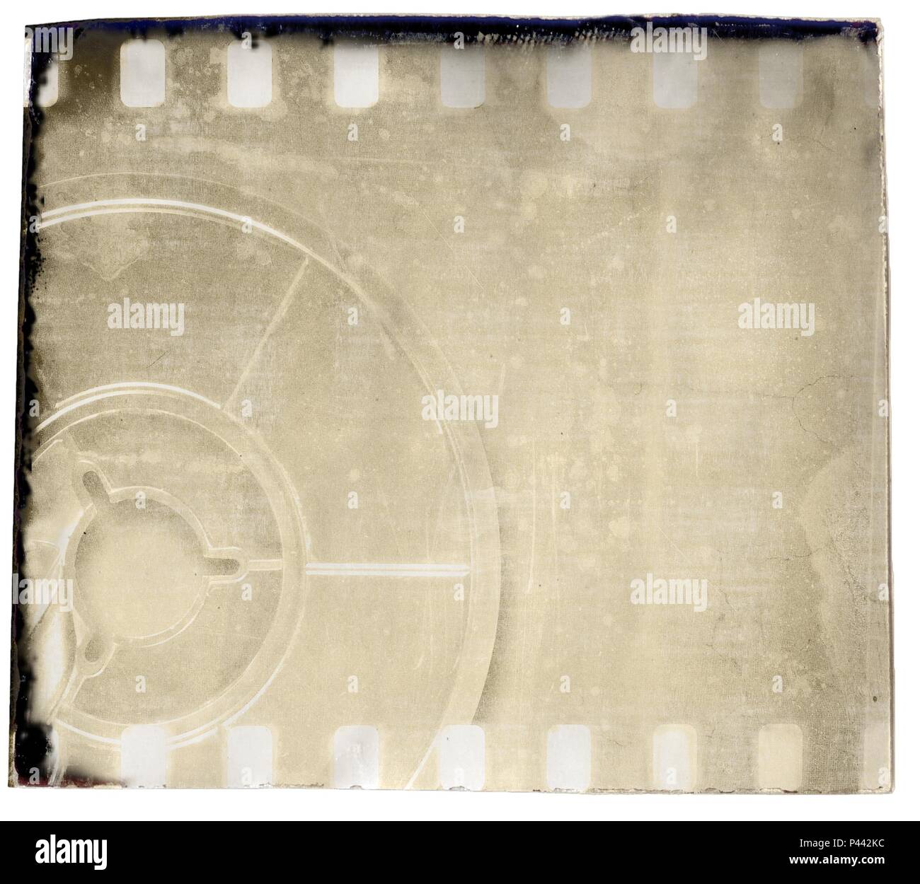 Old sepia film reel in film strip frame on a scratched and rusty metal ...