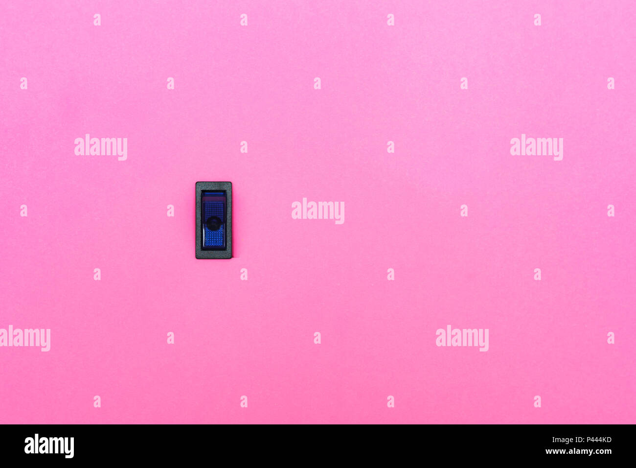 Blue toggle switch on a pink background. Abstract photo with blank ...