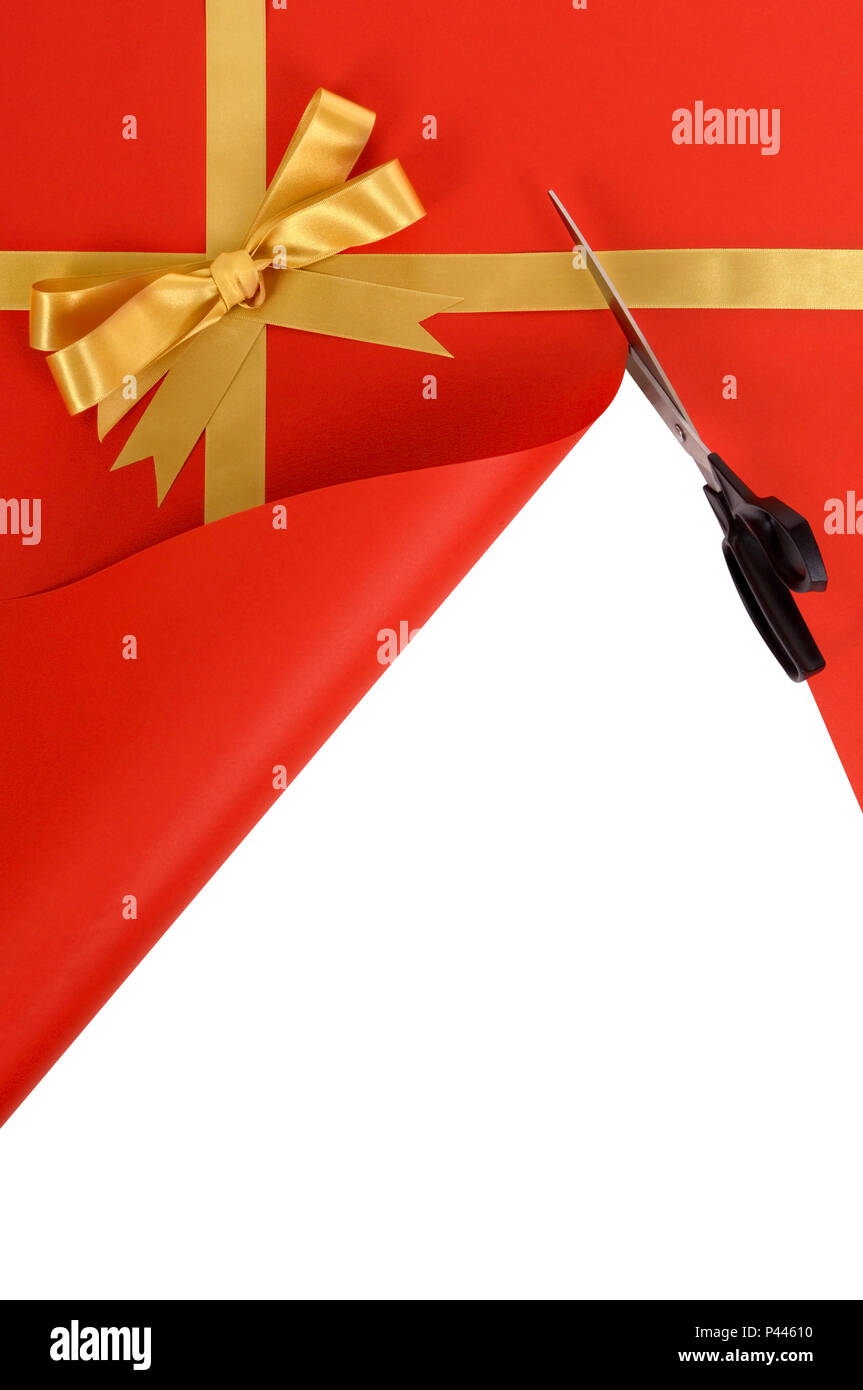 Scissors cutting open red and gold Christmas gift Stock Photo - Alamy