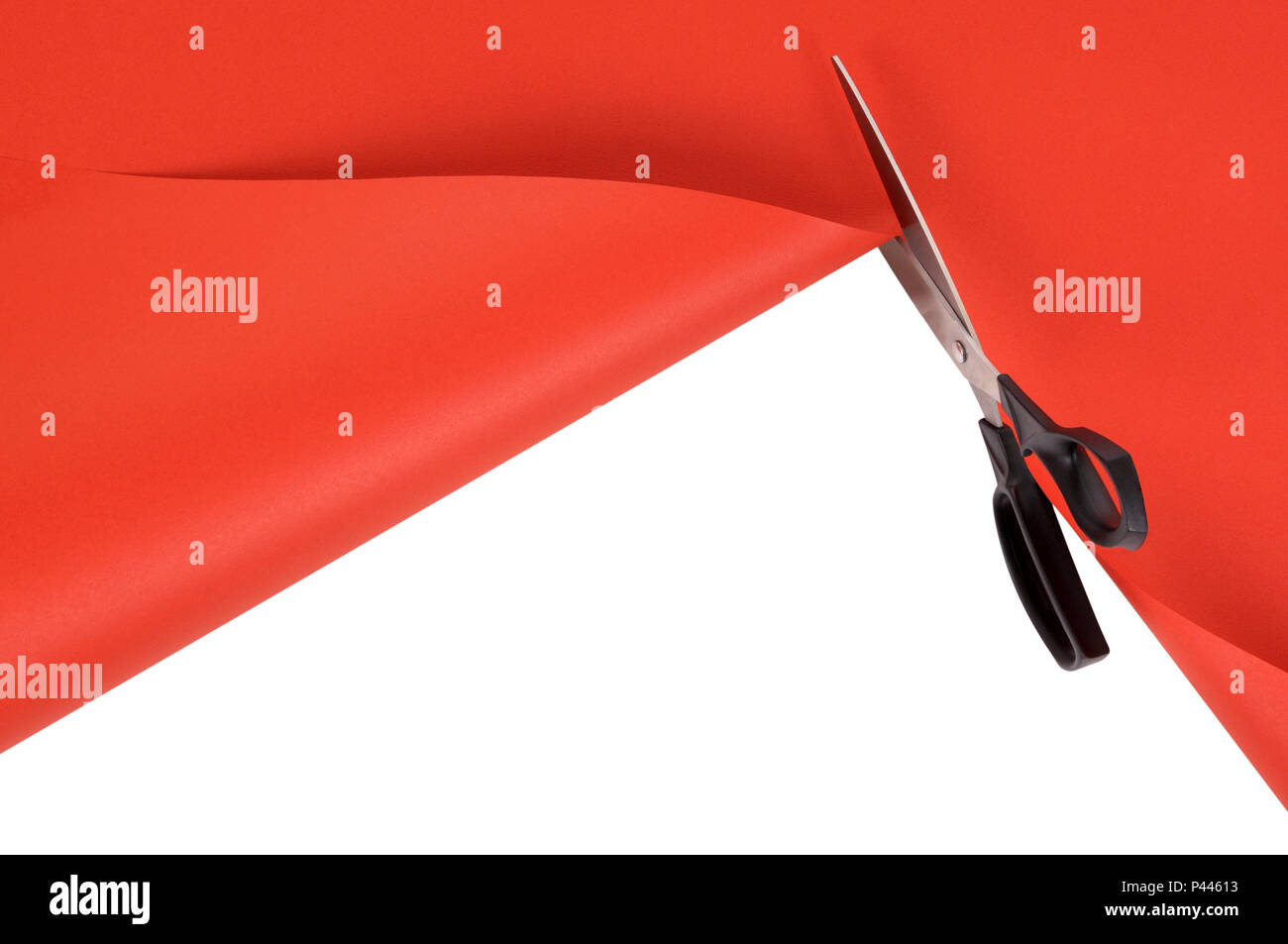 Scissors cutting red craft paper Stock Photo - Alamy