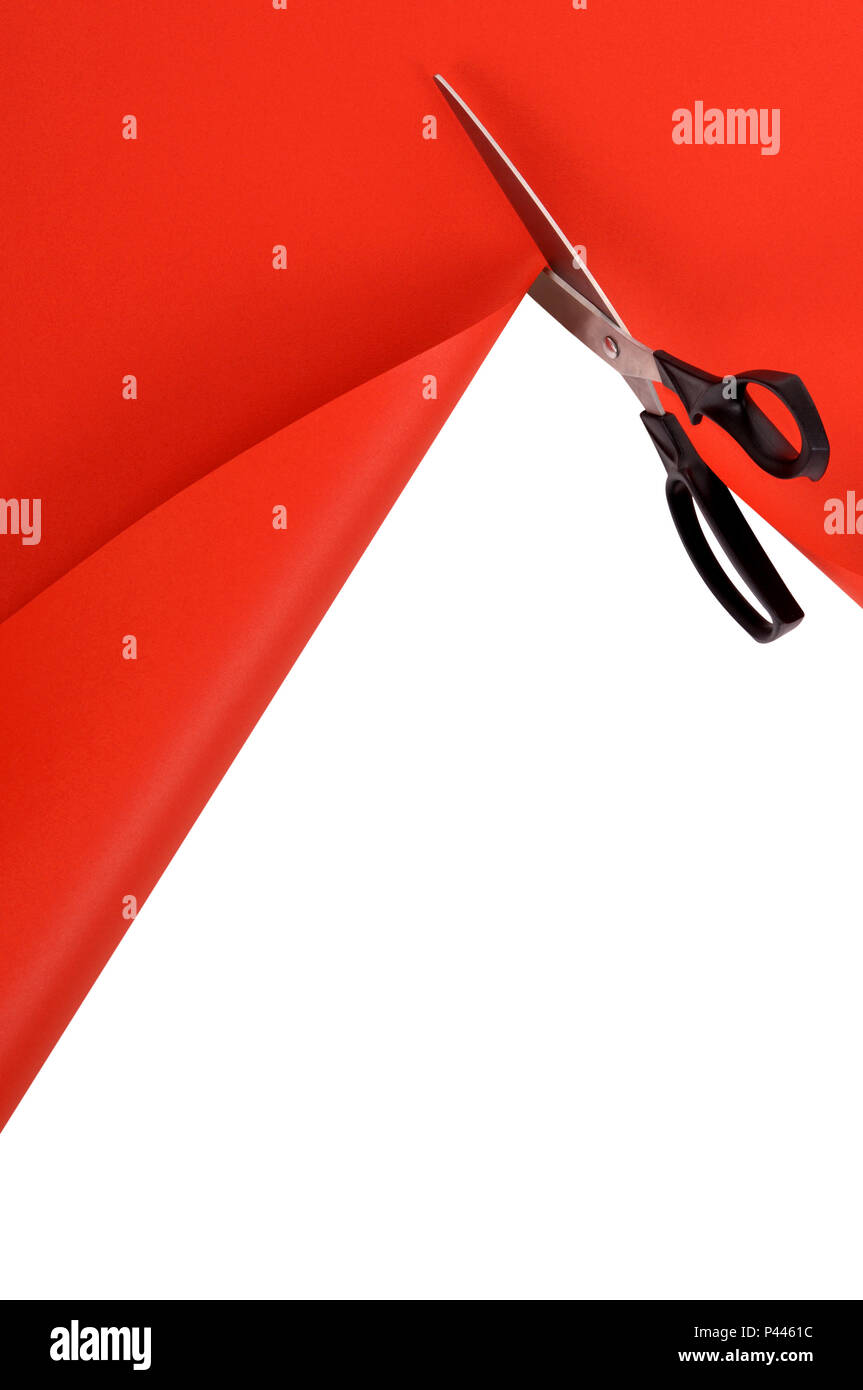 Scissors cutting red craft paper Stock Photo - Alamy