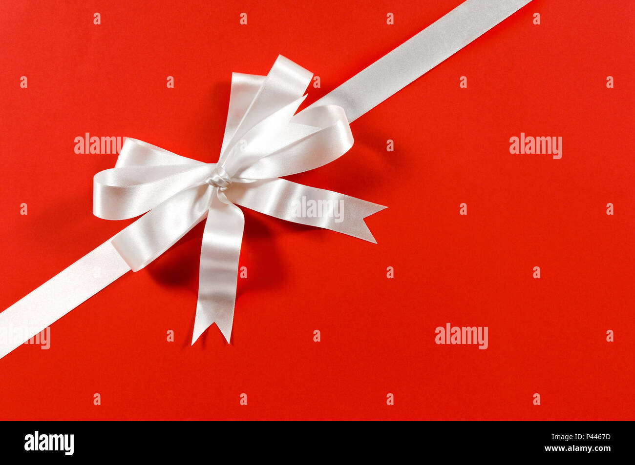 Christmas border frame gift ribbon in white satin on red paper ...